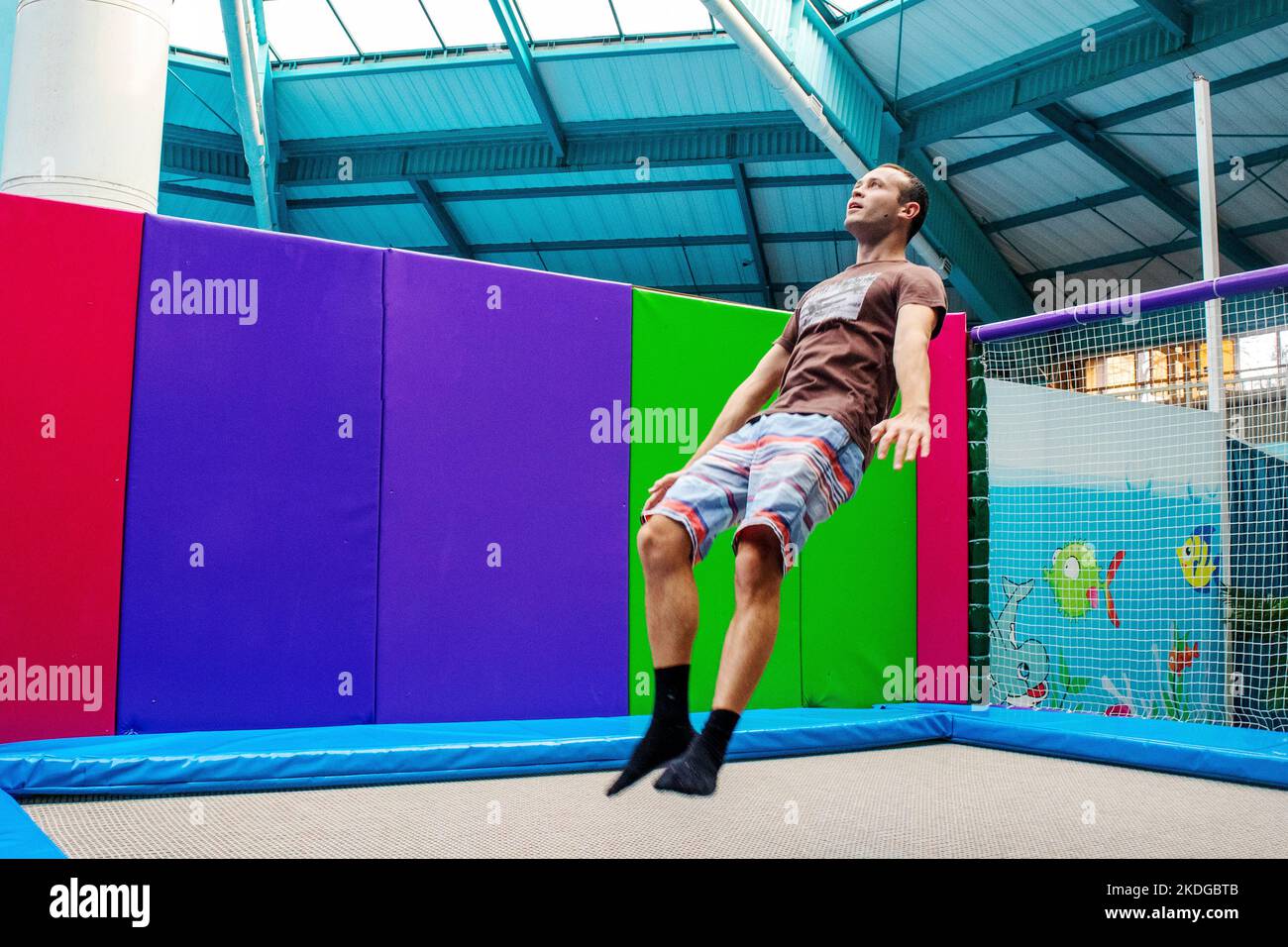 a guy jumps on a trampoline. fun trampoline Stock Photo - Alamy