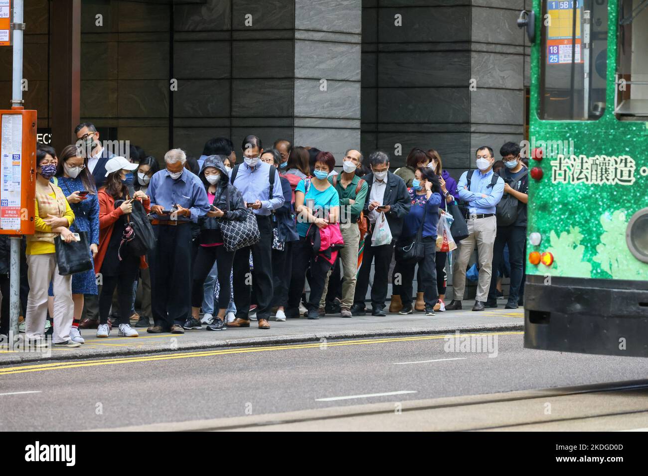 Commuters wait for the bus in Central as the Hong Kong Observatory ...