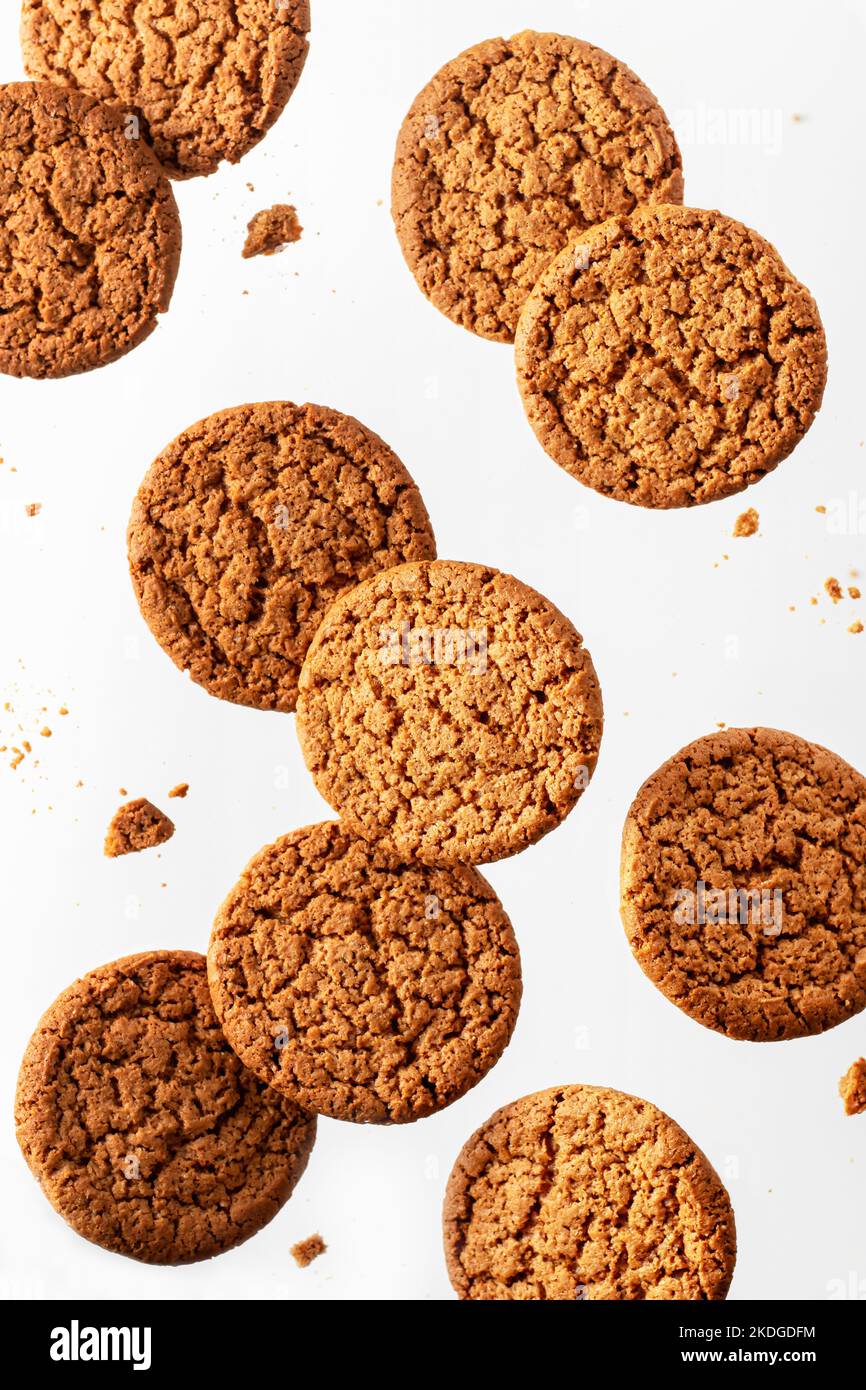 Flying oatmeal cookies with crumbs isolated on white background. Flying ...