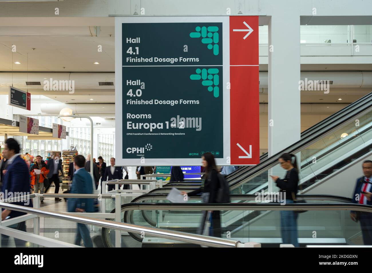 Visitors on escalator going past direction signs at CHPI 2022 in Messe ...