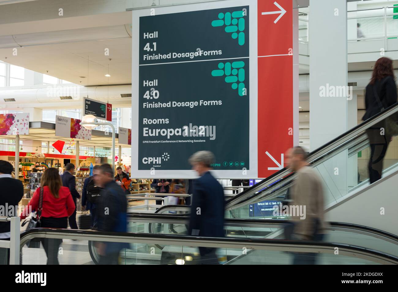 Visitors on escalator going past direction signs at CHPI 2022 in Messe ...