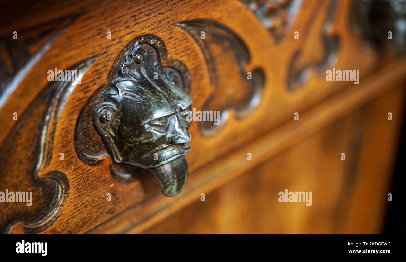 Drawer handles in the shape of a devil. Detail of an old Dutch cupboard ...