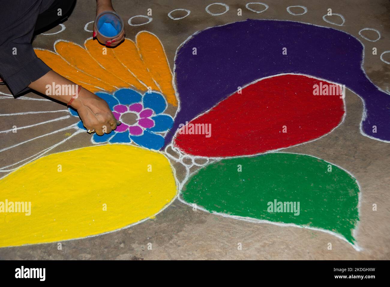 tribal people drawing rangoli on the eve of Diwali Stock Photo - Alamy