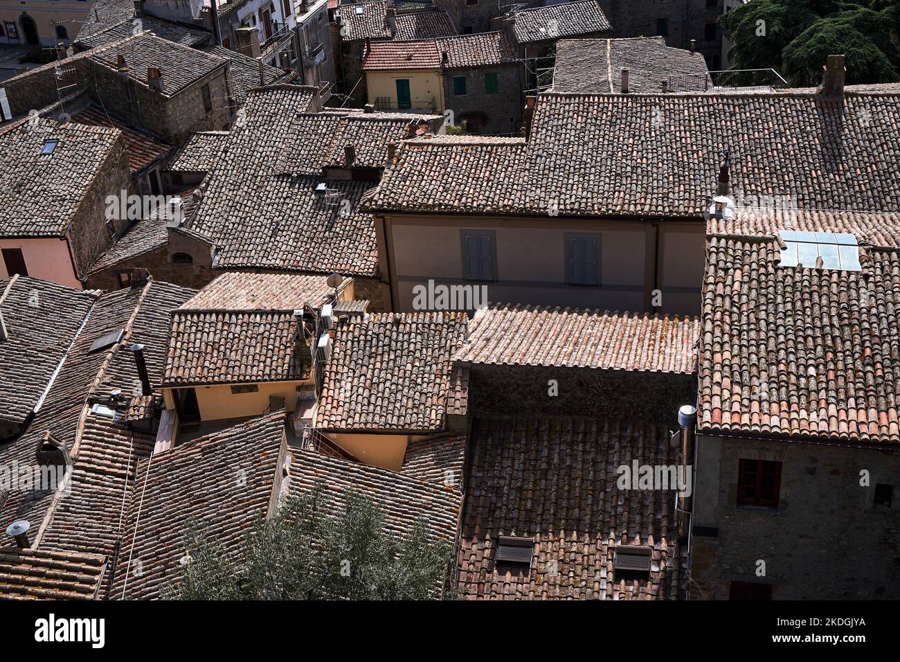 Tiled roofs, chimneys, windows and balconies in a city in Tuscany ...