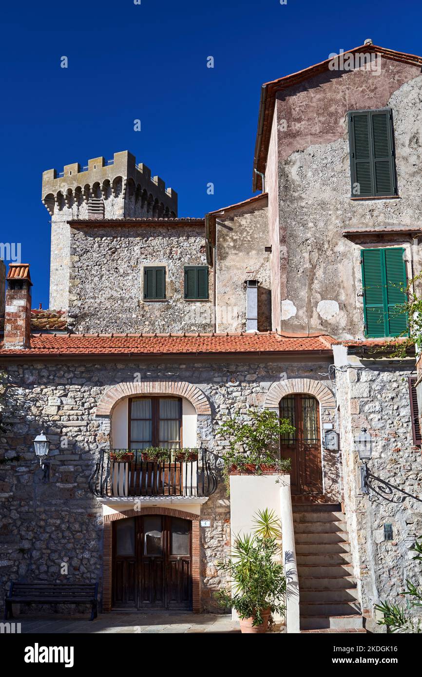 stone houses and the tower of a medieval castle in the town of Capalbio ...
