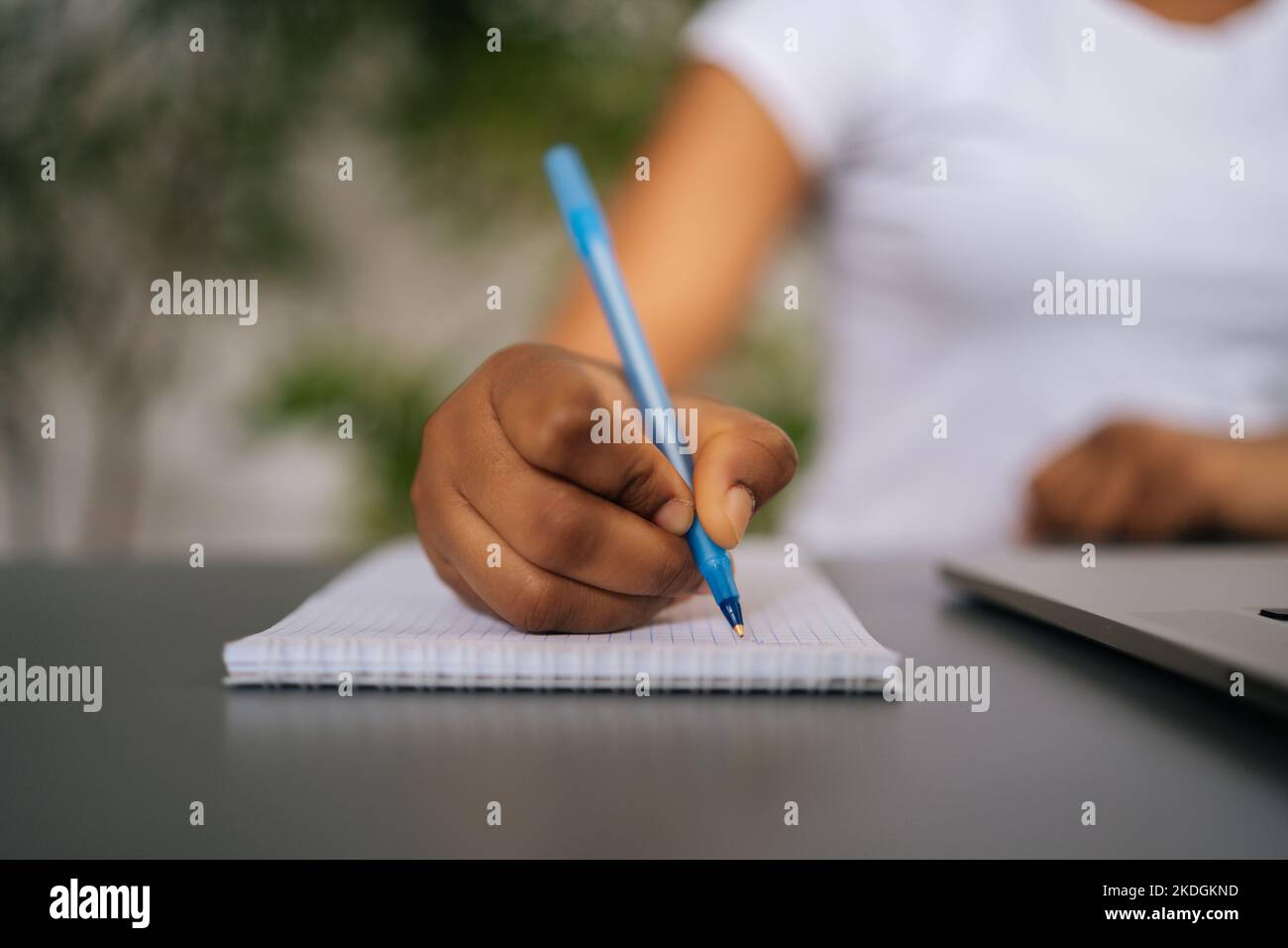 Close-up hands of unrecognizable African-American woman writing down ...