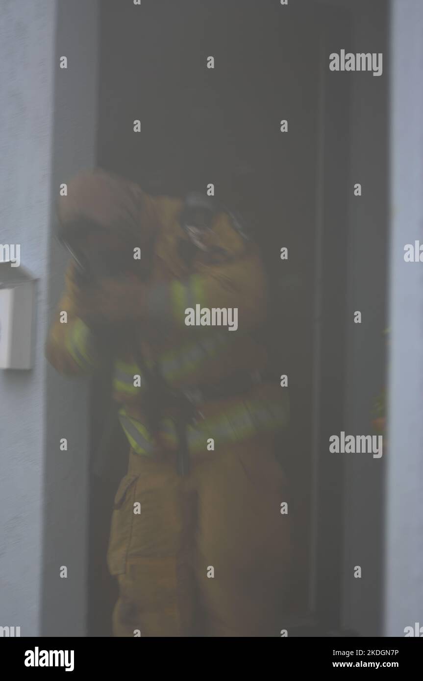 San Diego Fire-Rescue firefighter exits a working structure fire in the ...