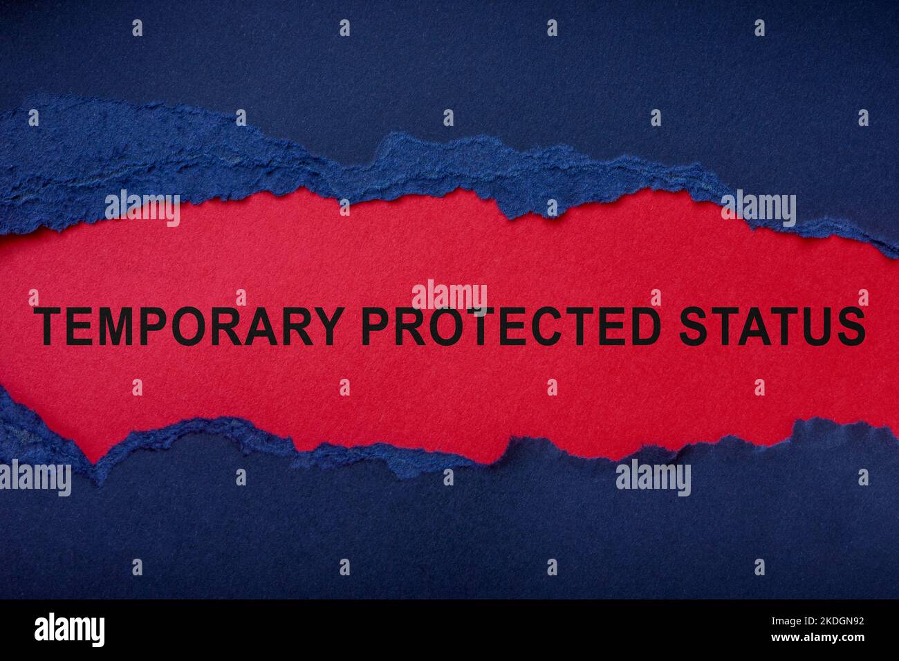 Temporary protected status inscription on a red sheet and a torn piece ...