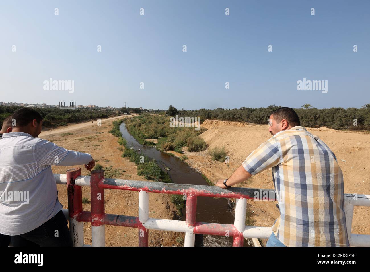 Palestinian engineers from the UNDP look from a bridge above to the ...
