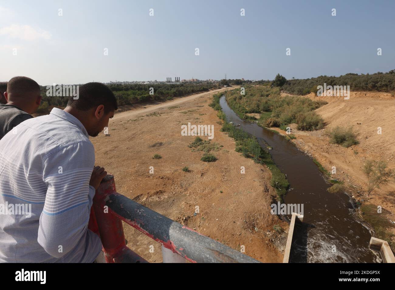Palestinian engineers from the UNDP look from a bridge above to the ...