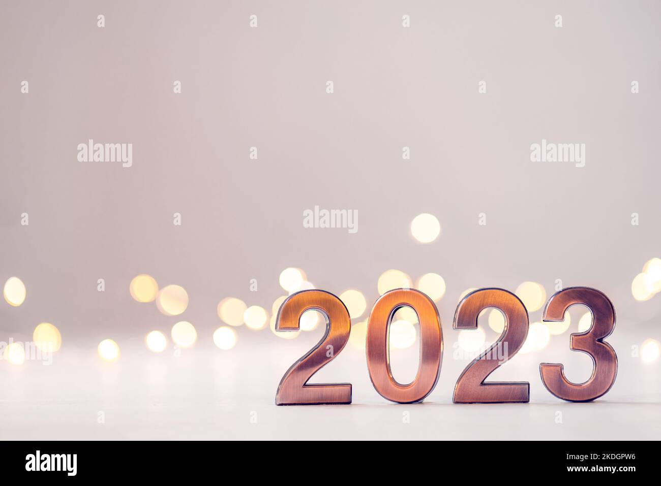 Metal numbers 2023 on table with bokeh lights Stock Photo - Alamy