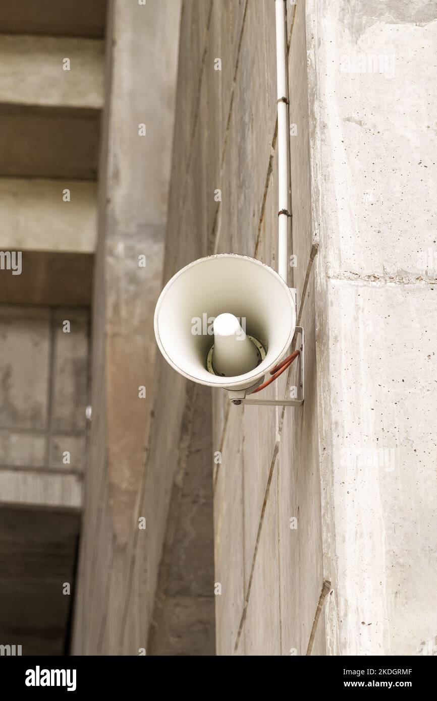 Wired loudspeaker on the wall of the building close-up. Announcement of ...