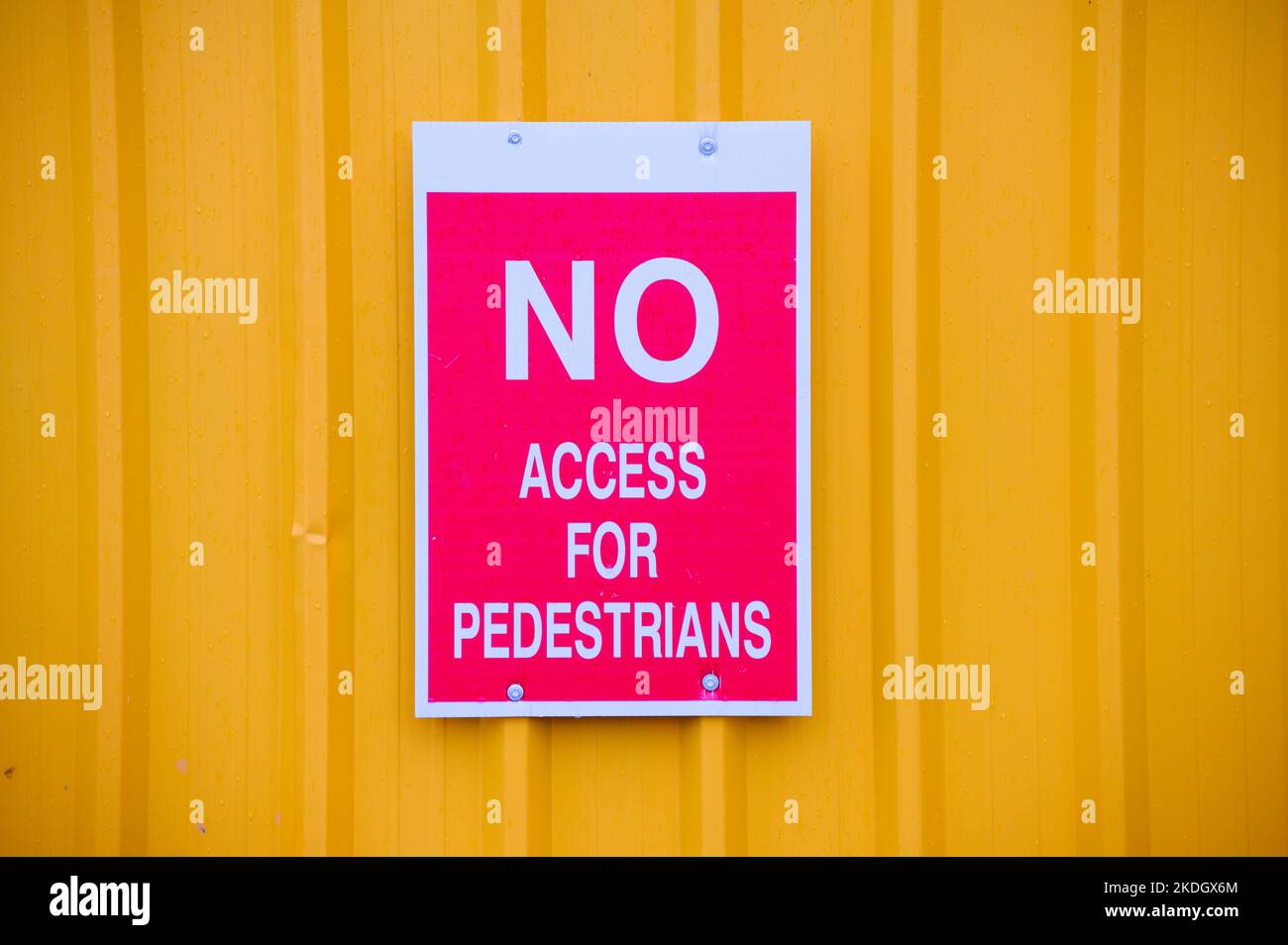 Pedestrian walkway sign at construction building site fence Stock Photo ...