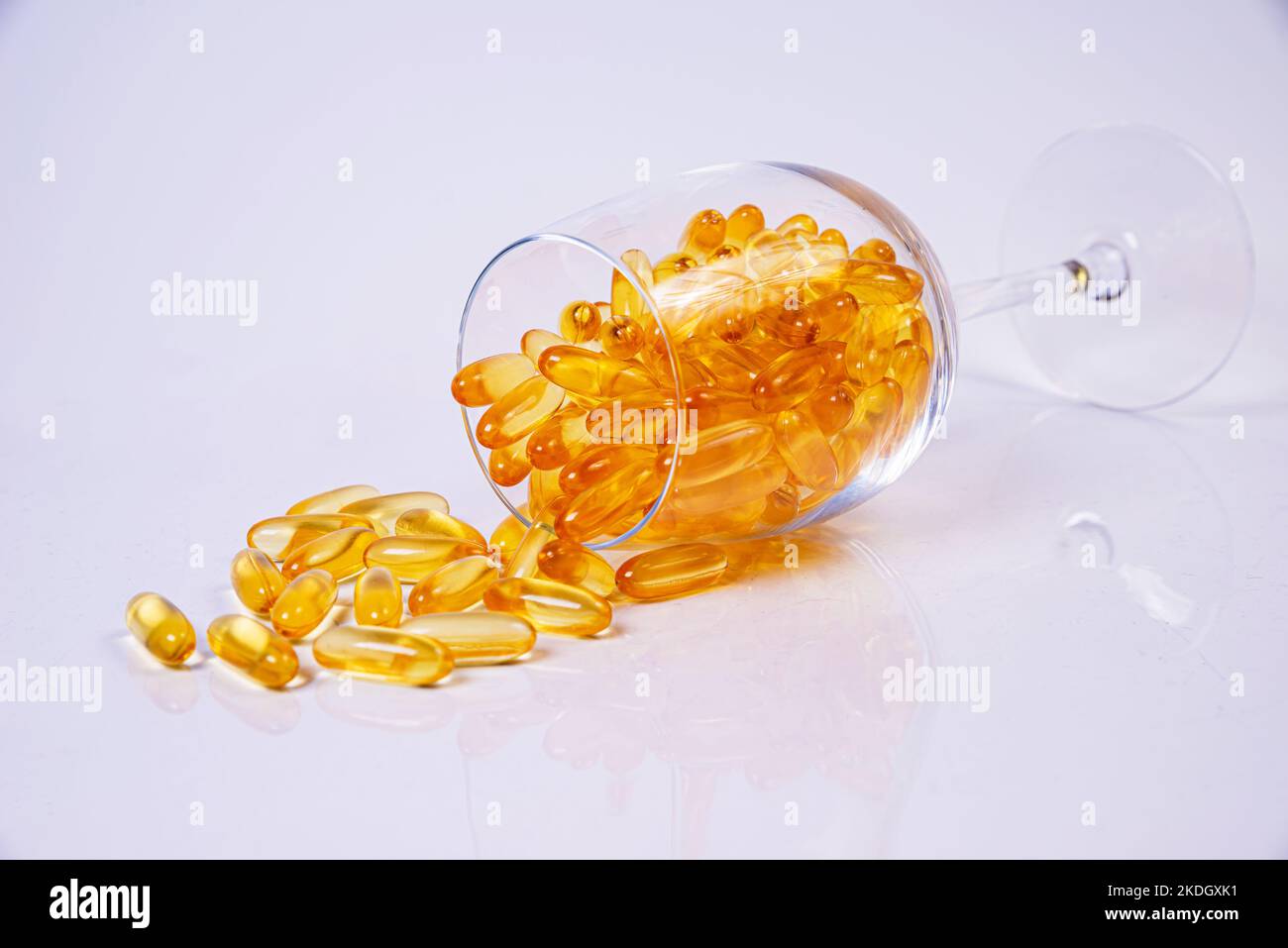 Fish oil capsules. Yellow omega 3 pills in jar on the dark black. fish ...