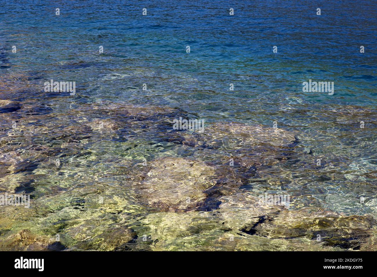 Transparent sea surface with stones on a bottom. Rocky beach, turquoise ...