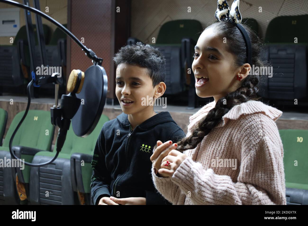 Two children, Jihad and Rawaa, are seen rehearsing a new audio cartoon ...