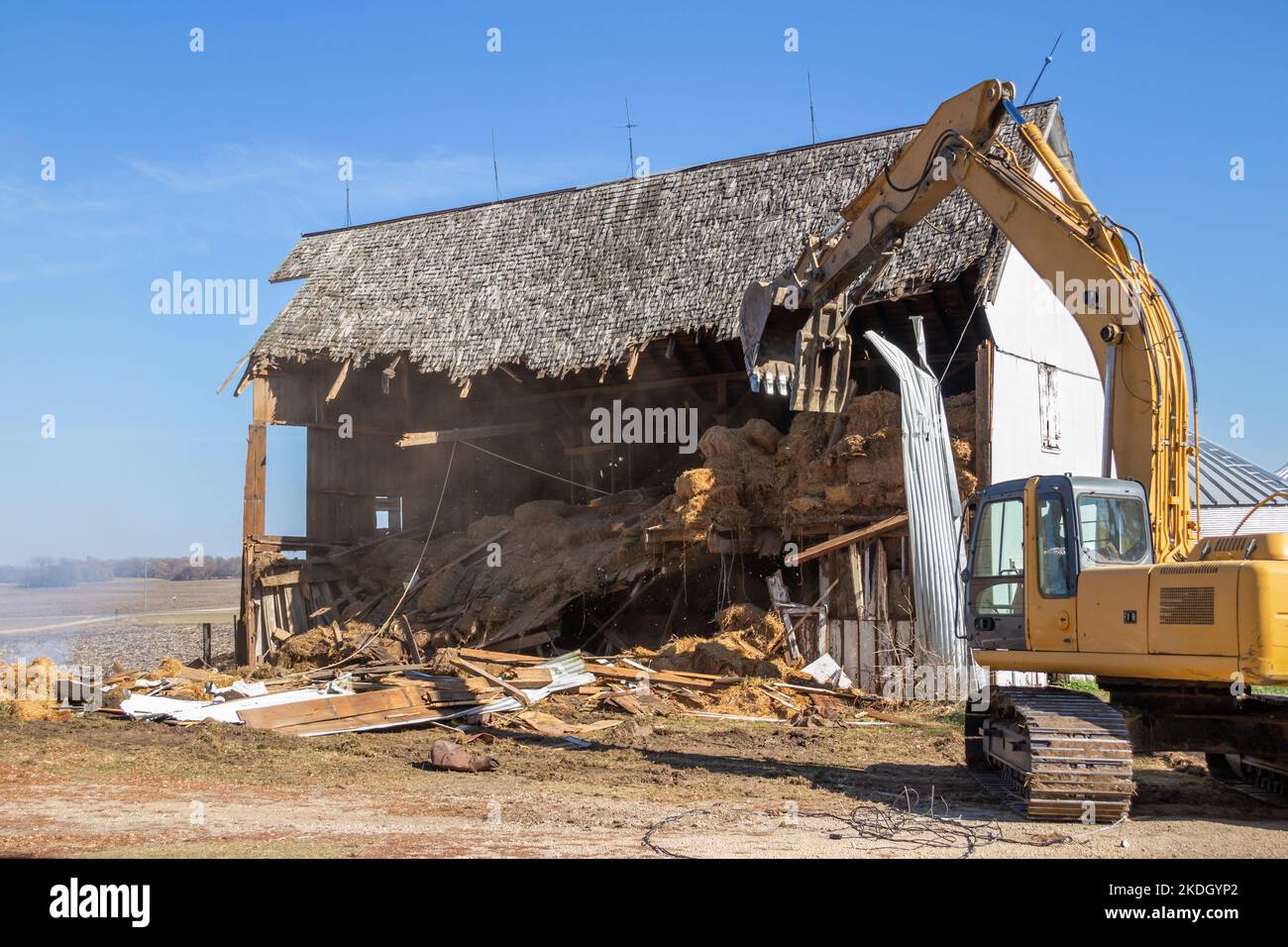 Close up view of an old abandoned barn building being demolished with a ...