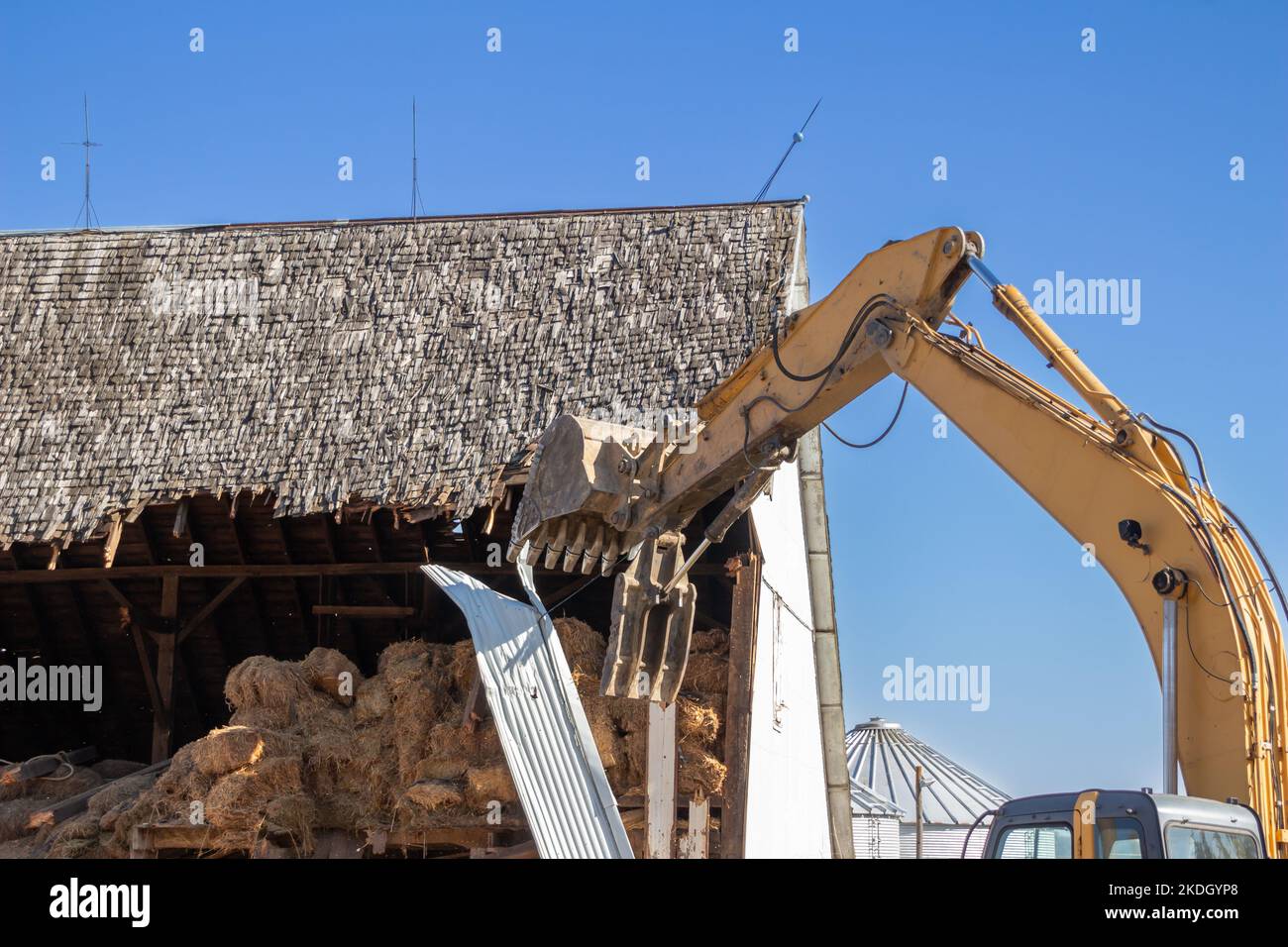Close up view of an old abandoned barn building being demolished with a ...