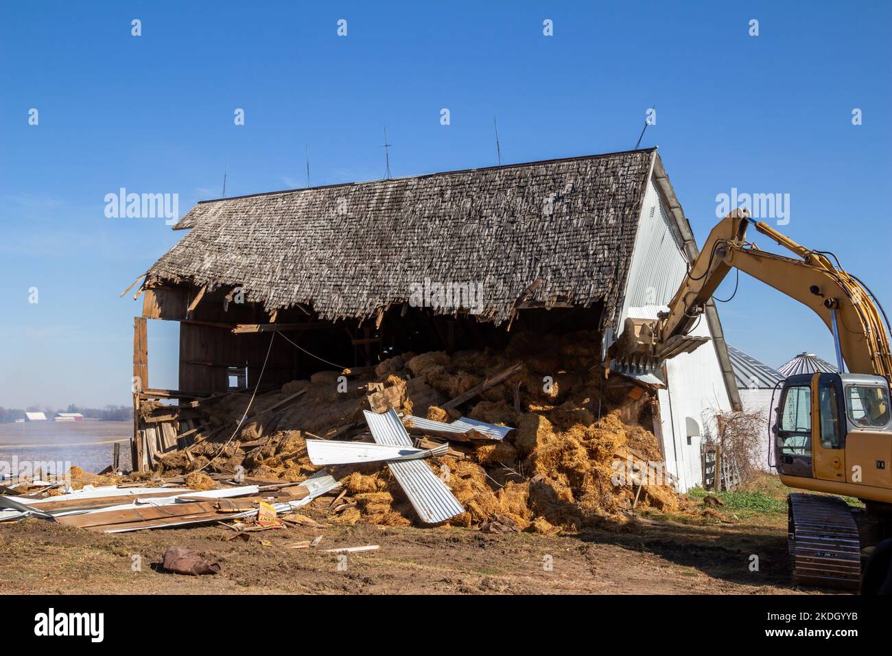 Close up view of an old abandoned barn building being demolished with a ...