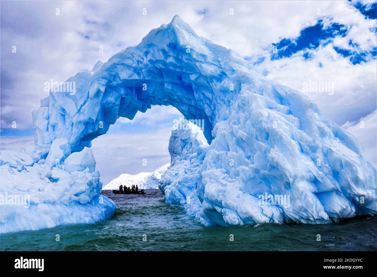 An iceberg of blue ice in Antarctica with an interesting hole / arch ...