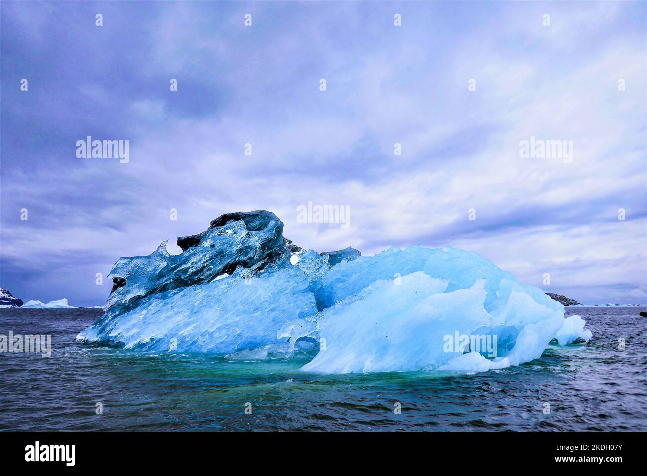 An iceberg of blue ice in Antarctica with an interesting hole / arch ...