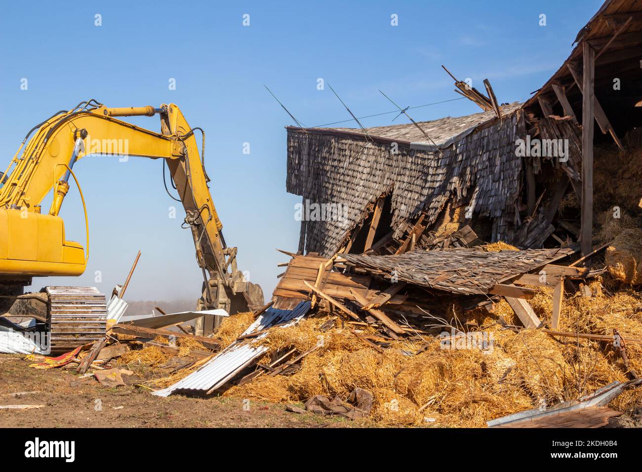Close up view of an old abandoned barn building being demolished with a ...