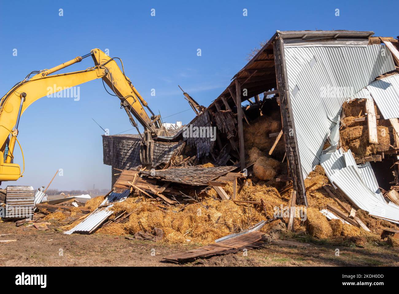 Close up view of an old abandoned barn building being demolished with a ...