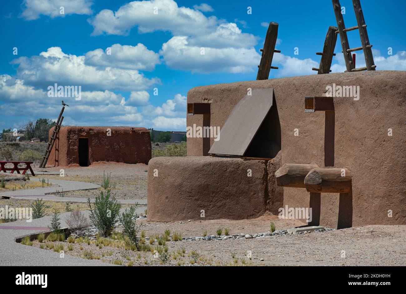 Traditional Native American Kiva in foreground with a single room ...