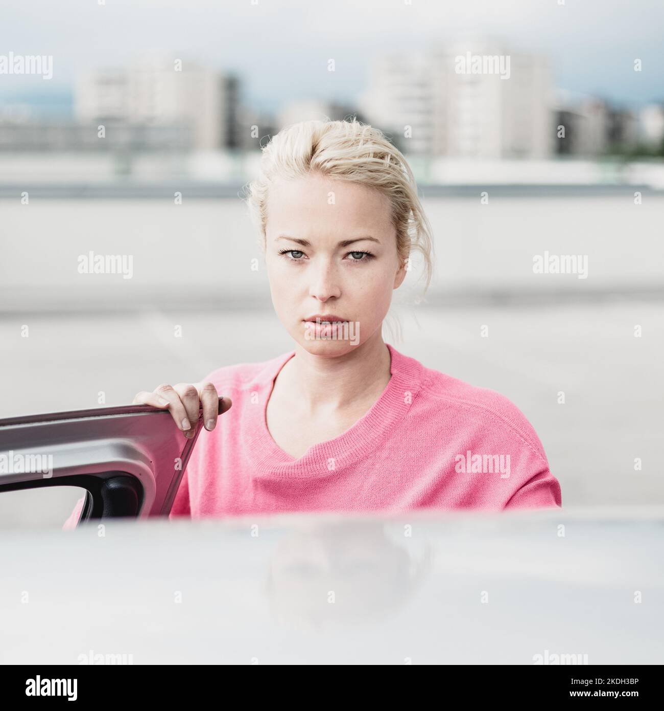 Portrait of responsible female driver holding car keys in her hand ...