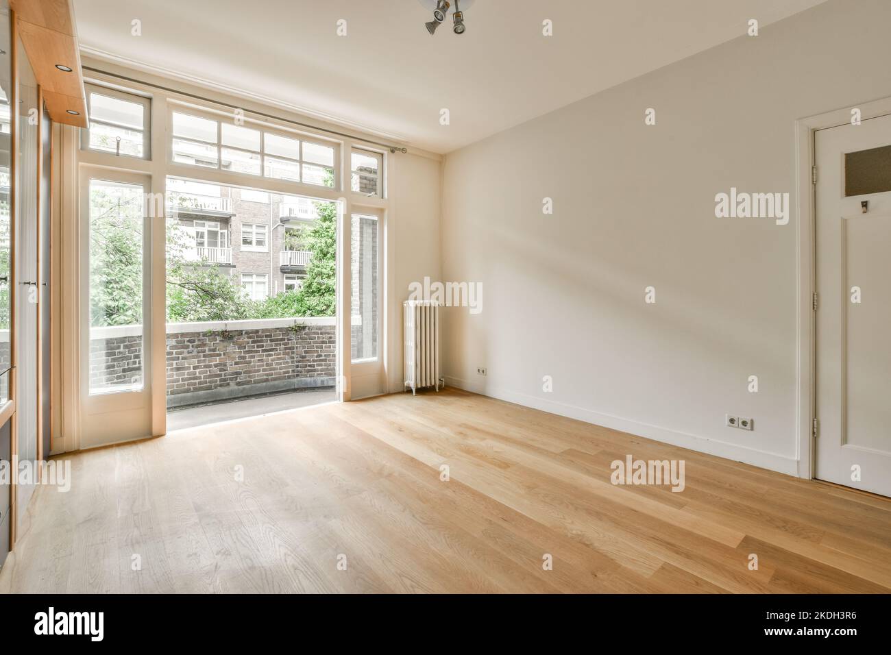 Interior of empty white room with large balcony windows with cupboard ...