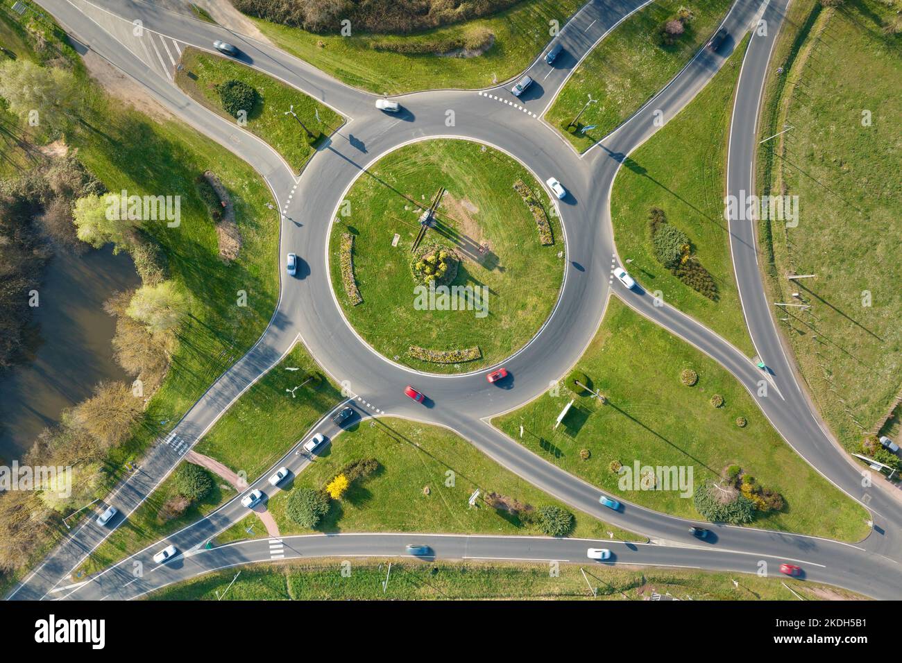Aerial view of road roundabout intersection with moving heavy traffic ...