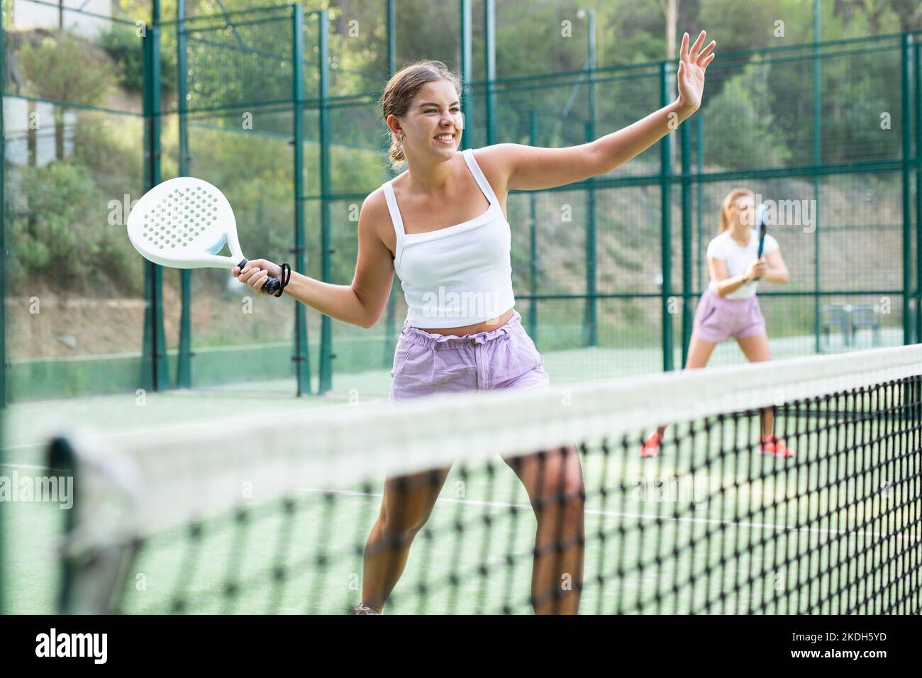 Young woman padel tennis player trains on the outdoor court Stock Photo ...