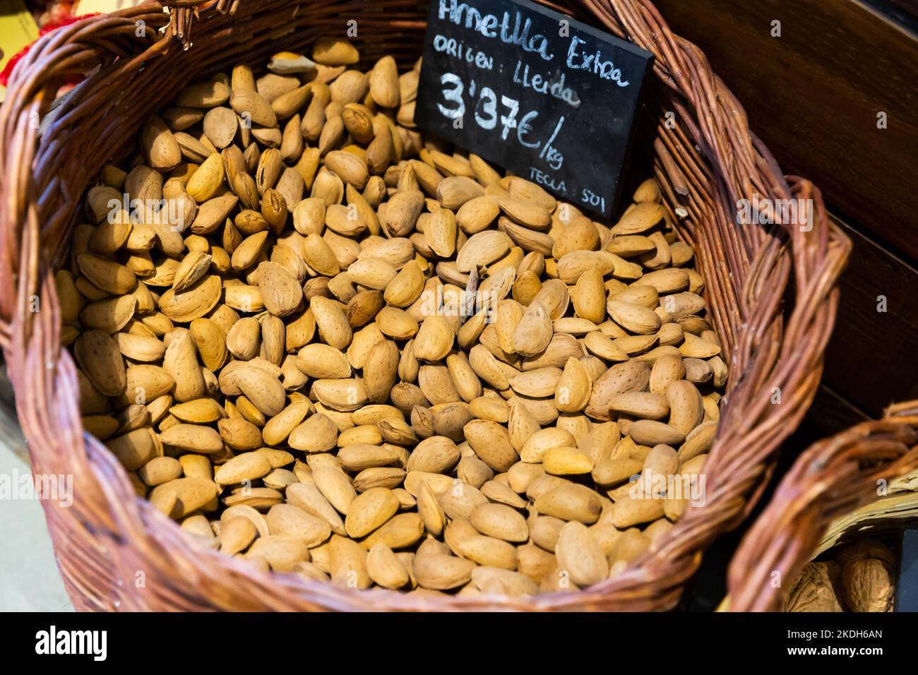 Almonds in wicker basket with price tag in Catalan Stock Photo - Alamy