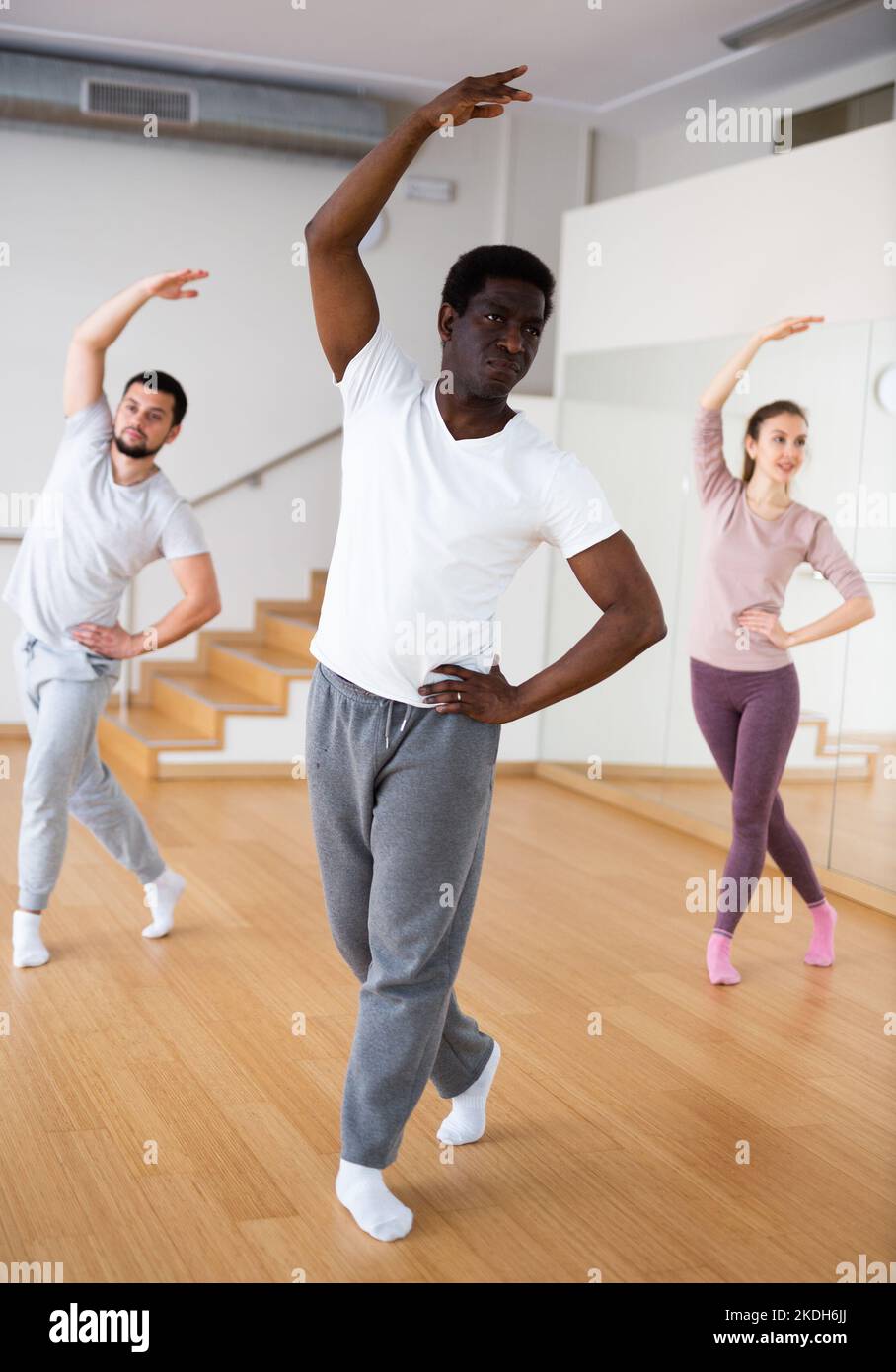 African-american man practicing classical dance moves with group Stock ...
