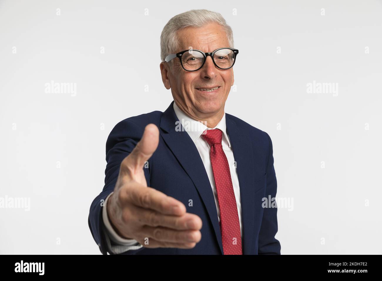 Businessman extending his arm to shake hands, being friendly, and ...