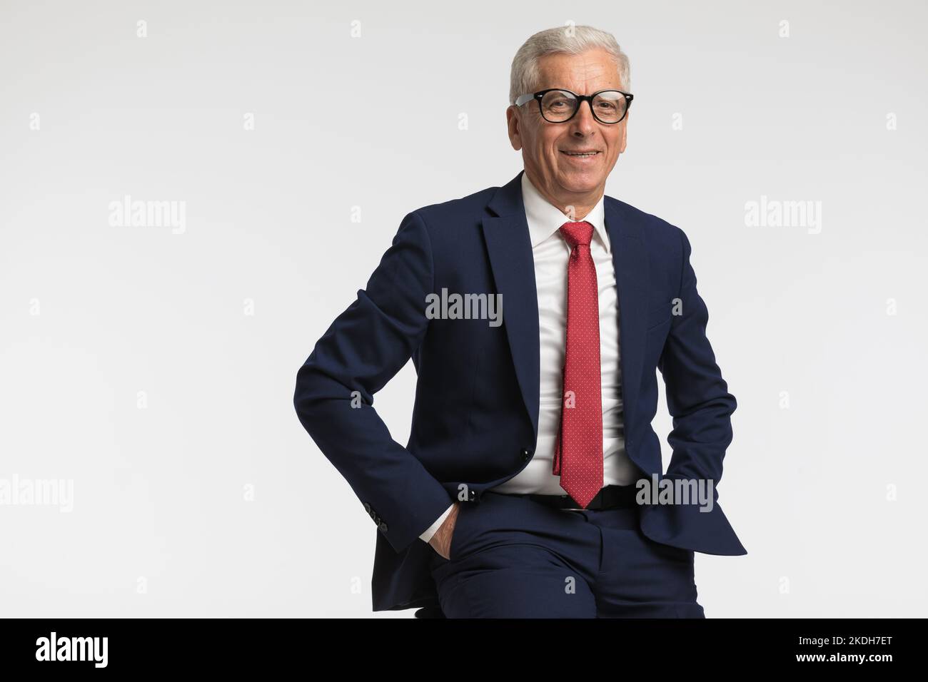 Business man with a smile on his face putting his hands in his pockets ...