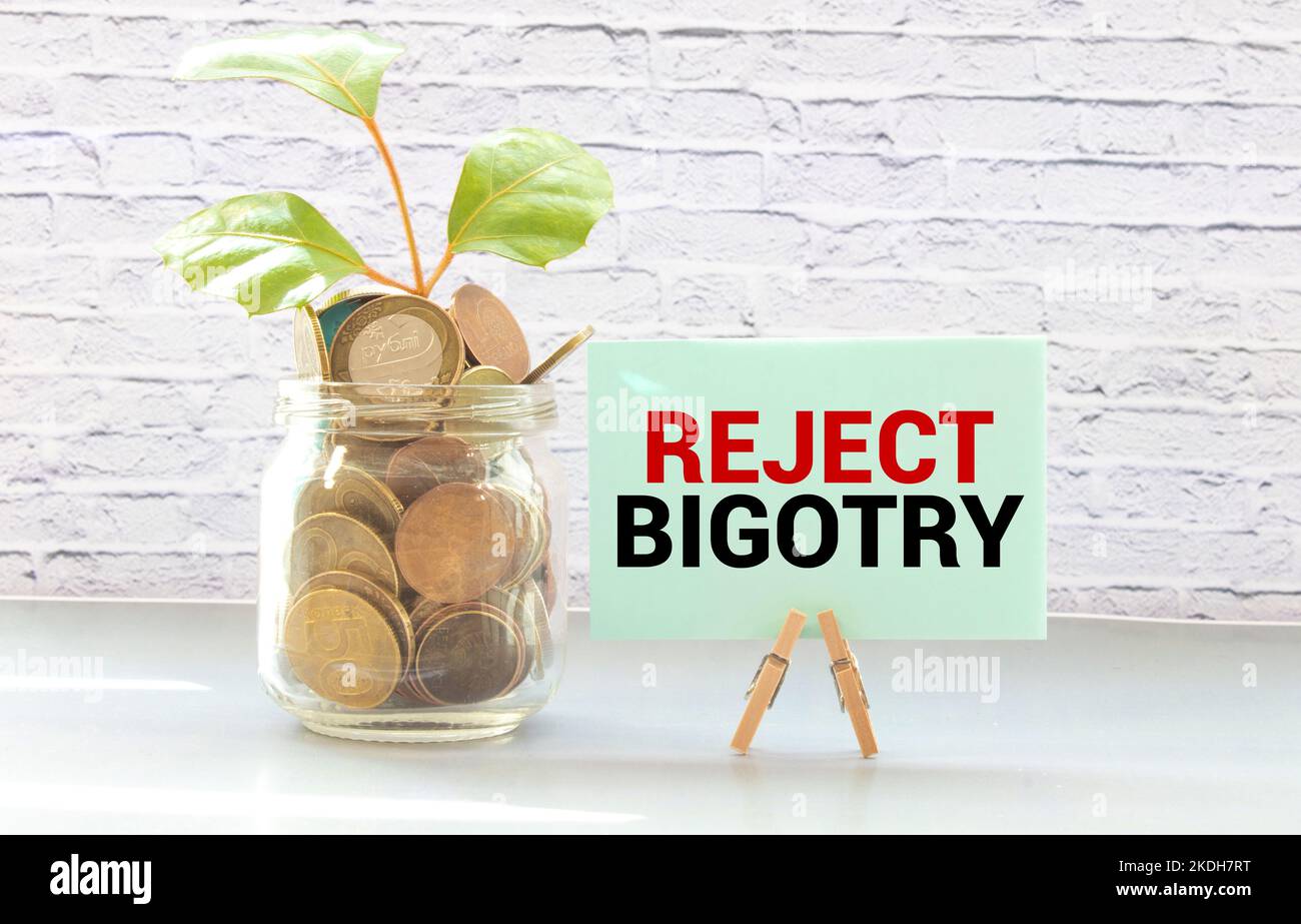 Text Prevent Bigotry written in blue under a wire mesh Stock Photo - Alamy