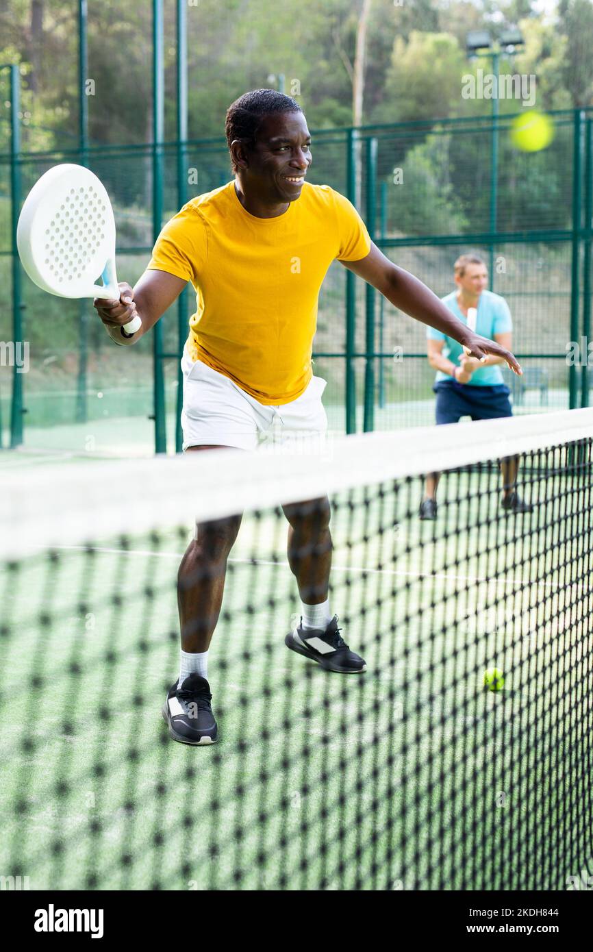 African american man playing padel tennis Stock Photo - Alamy