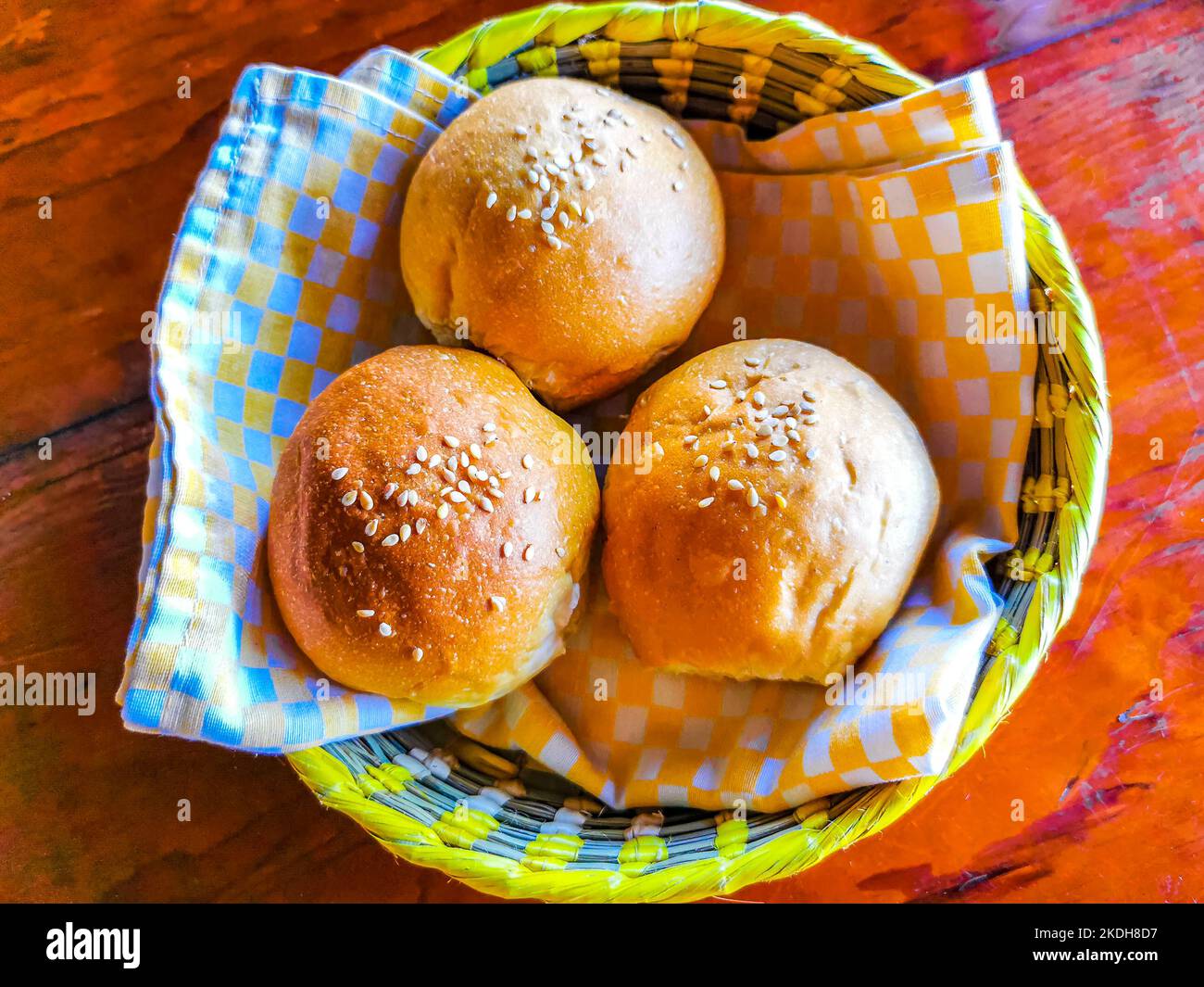 Delicious round buns with sesame seeds on wooden table in El Cafecito ...