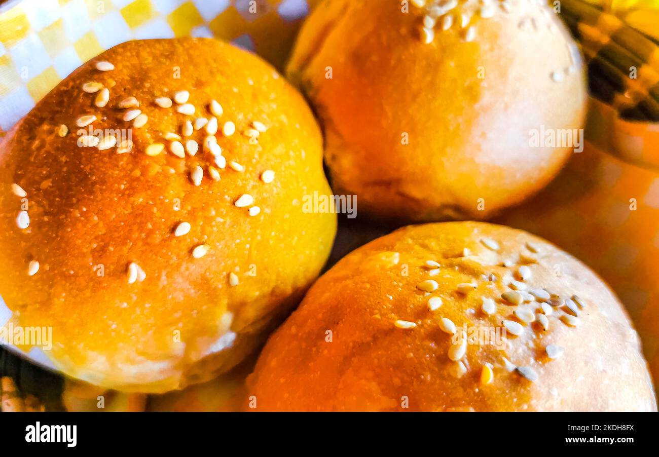 Delicious round buns with sesame seeds on wooden table in El Cafecito ...