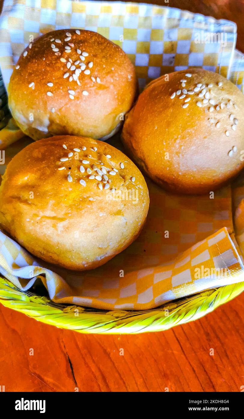 Delicious round buns with sesame seeds on wooden table in El Cafecito ...