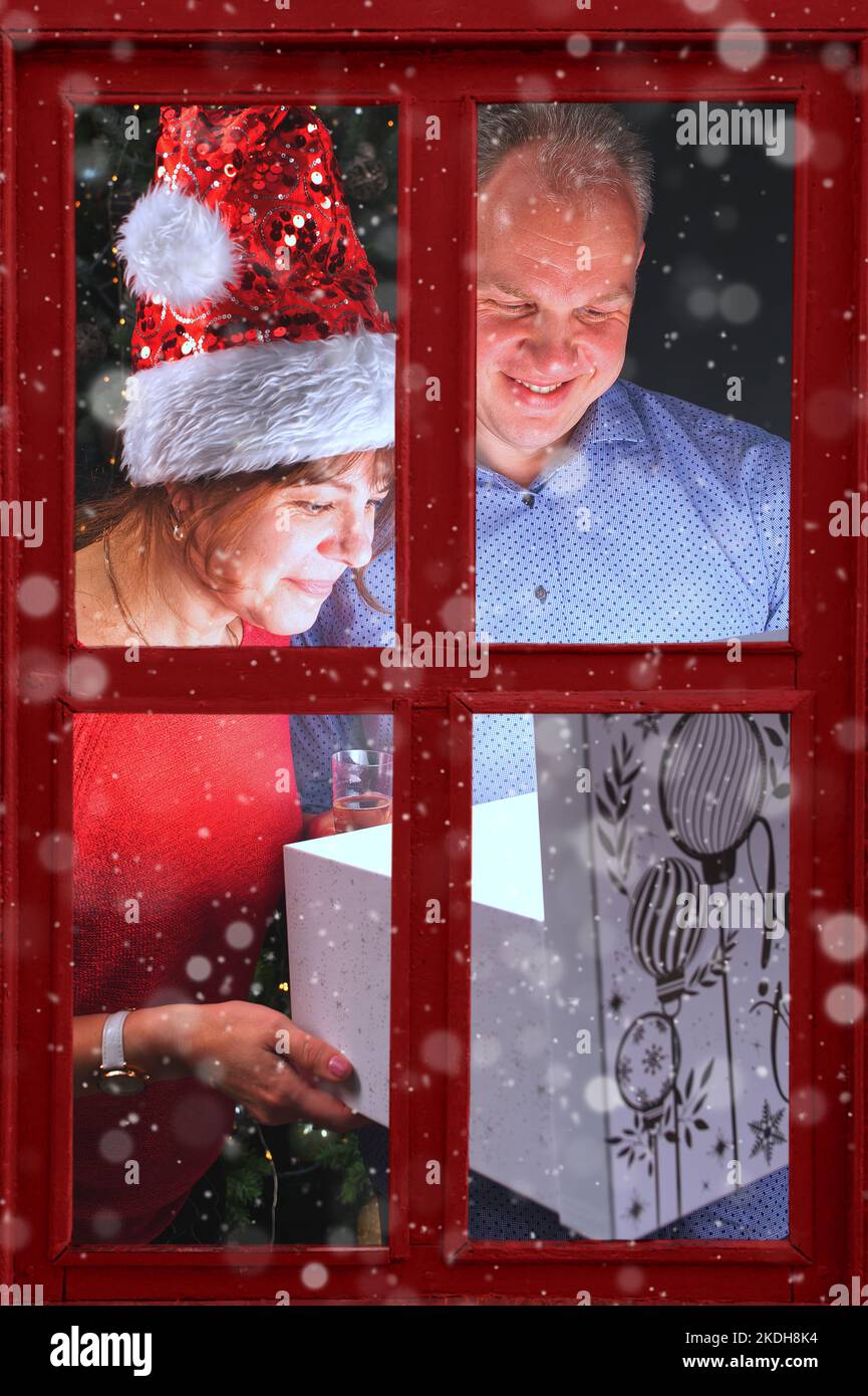 Christmas through the window. Christmas wonder. Man giving a Christmas ...