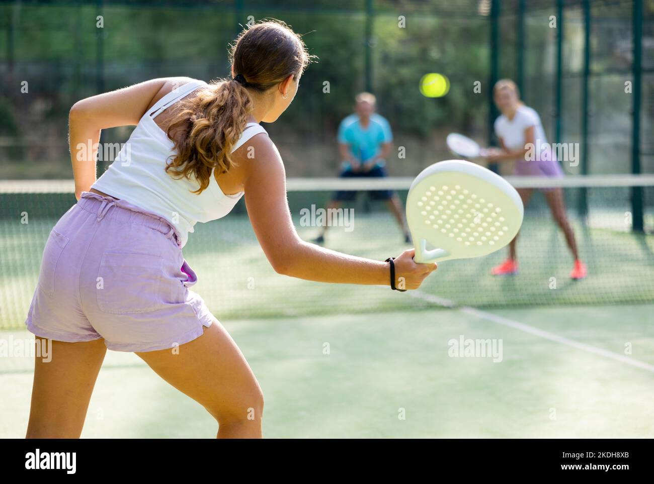 Rear photo of woman playing padel tennis on court Stock Photo - Alamy