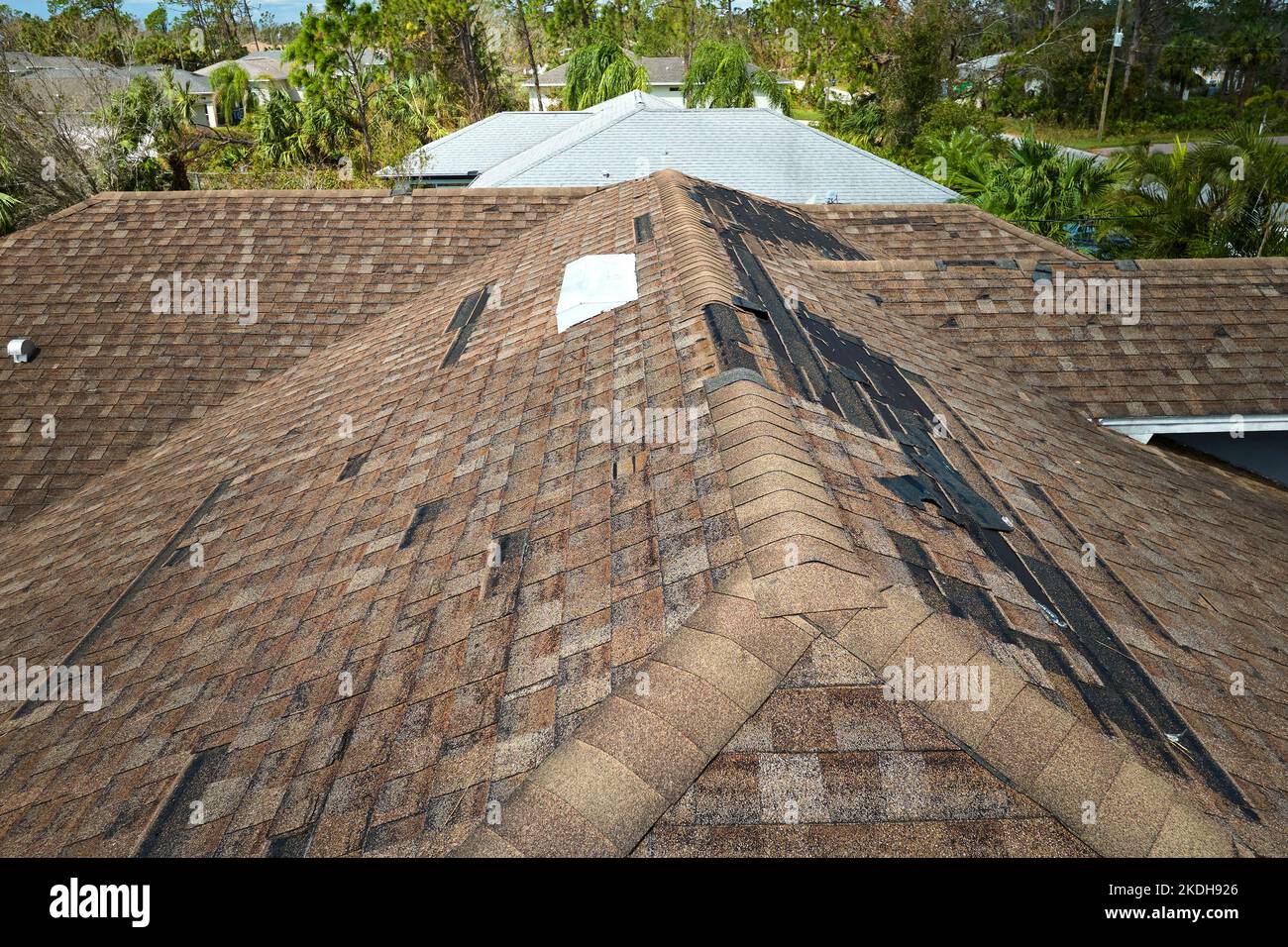 Damaged house roof with missing shingles after hurricane Ian in Florida ...