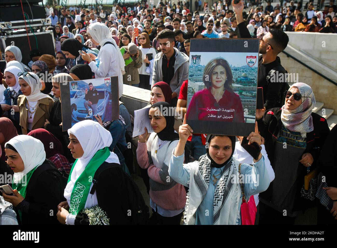 A Palestinian student from An-Najah University holds a picture of ...