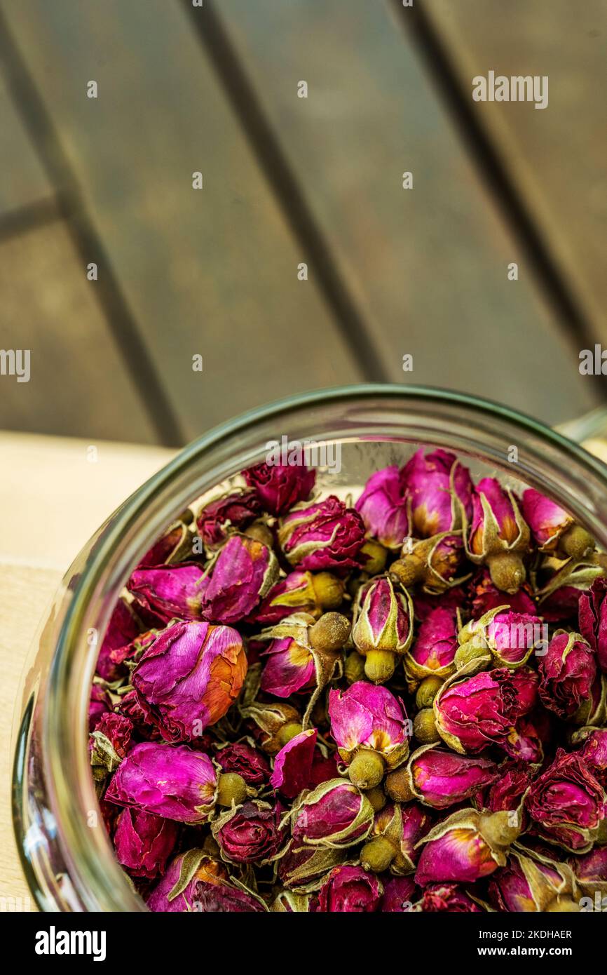 A glass container filled with dried rose buds to make tea Stock Photo ...