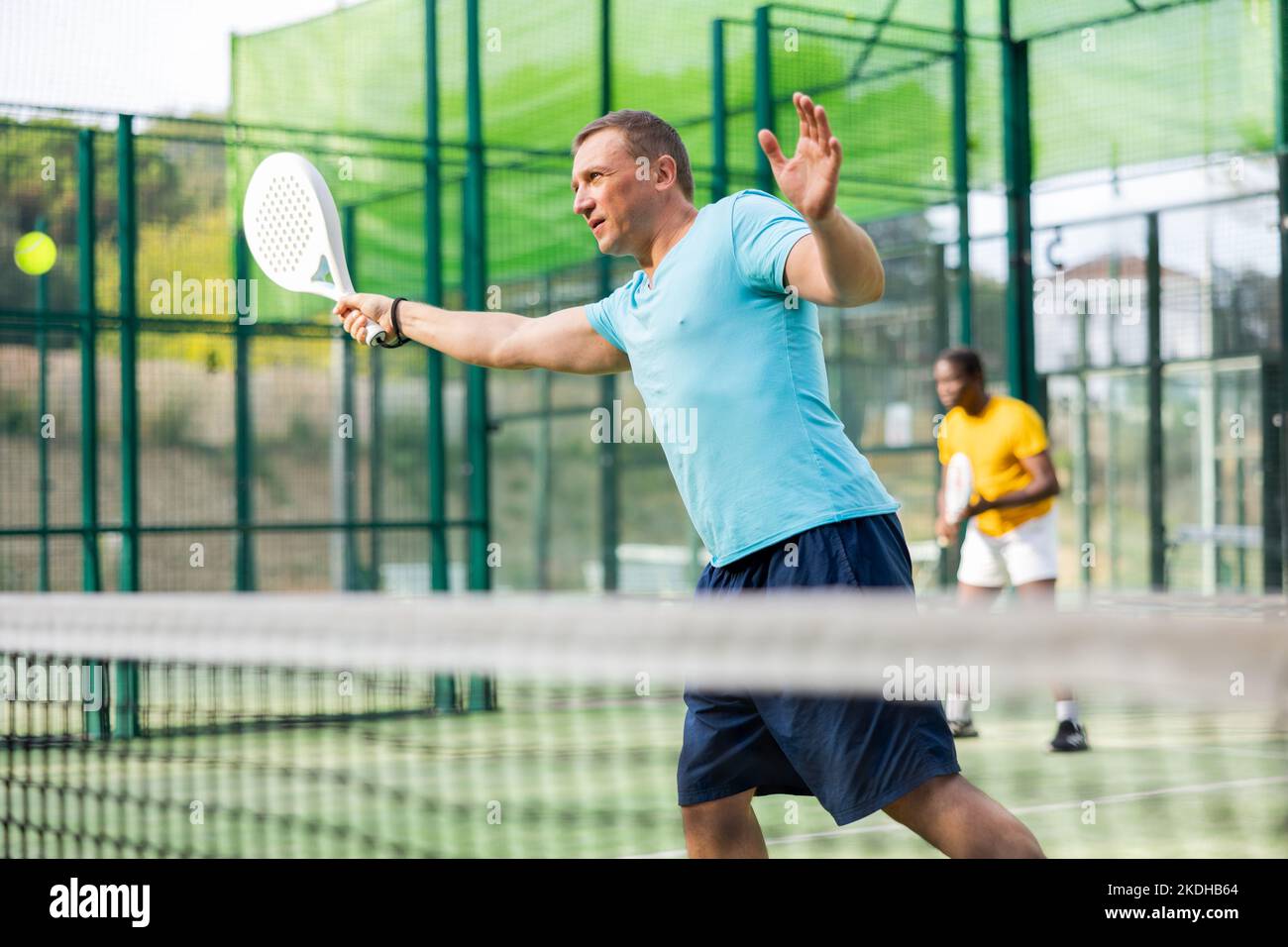 Man playing padel tennis on court Stock Photo - Alamy