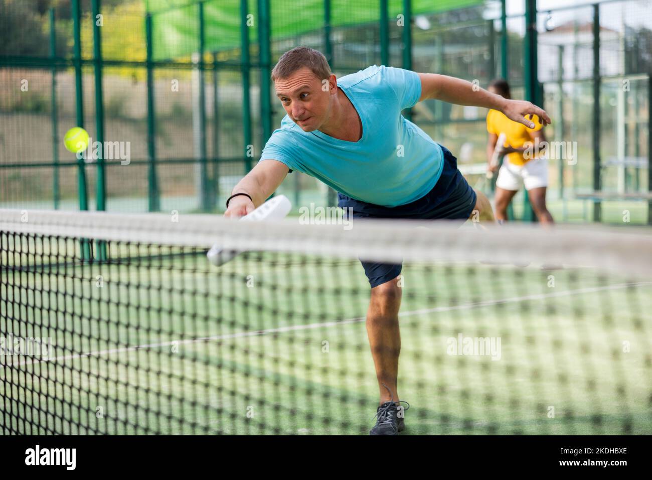 Man playing padel tennis on court Stock Photo - Alamy