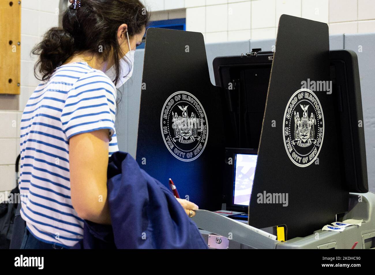 A voter entering their ballot into a scanner at West Side High School ...