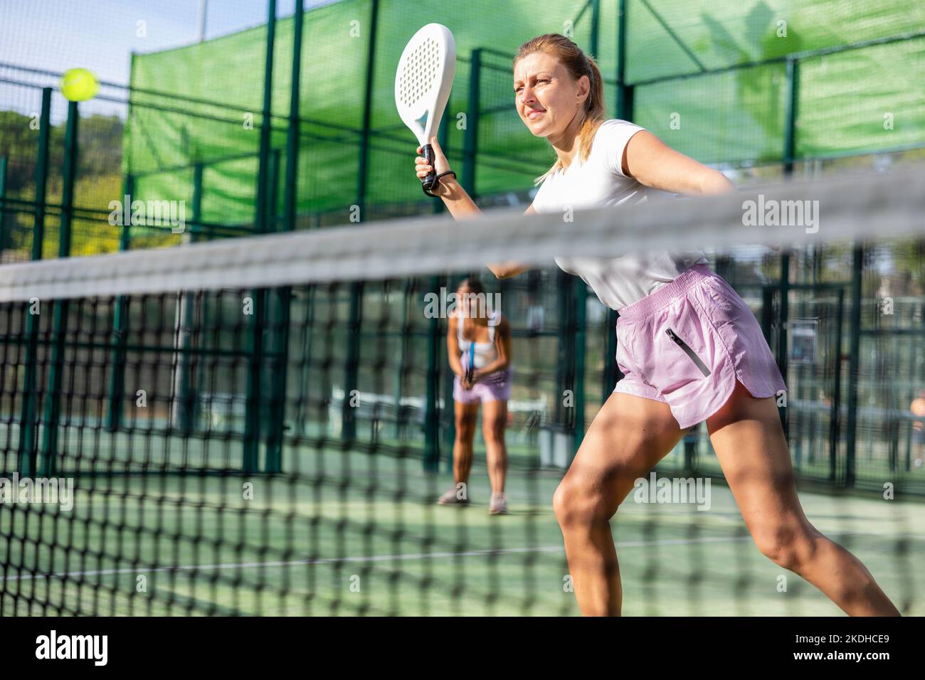 European woman padel tennis player trains on the outdoor court Stock ...